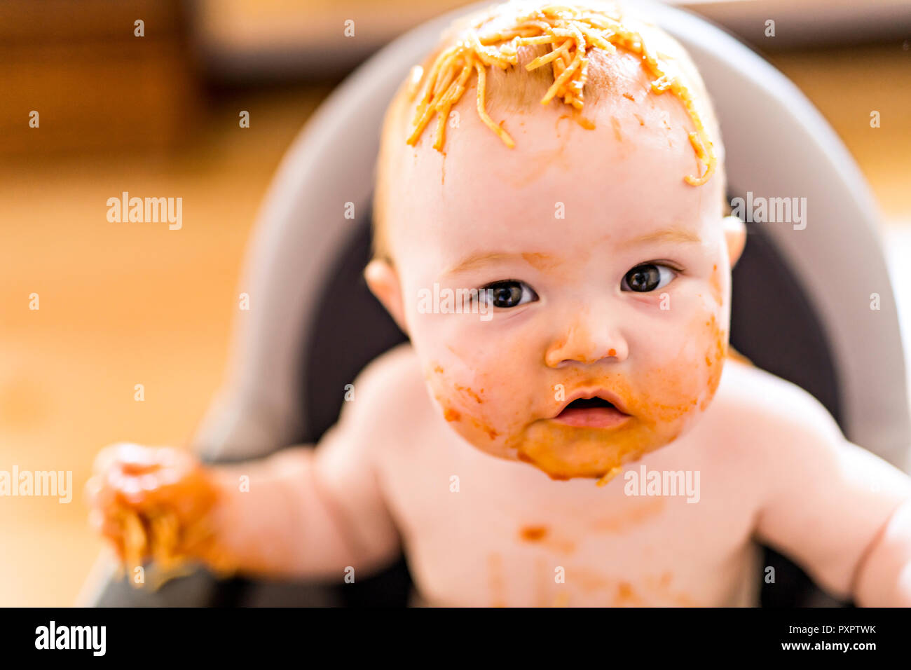 Little baby girl eating her spaghetti dinner and making a mess Stock ...