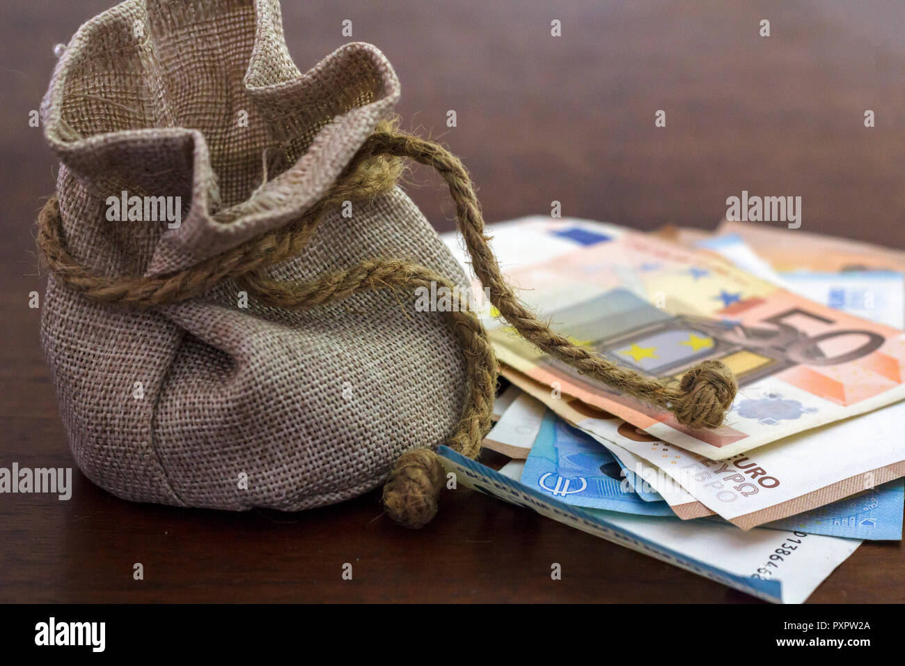 Money bag and euro banknotes Stock Photo - Alamy