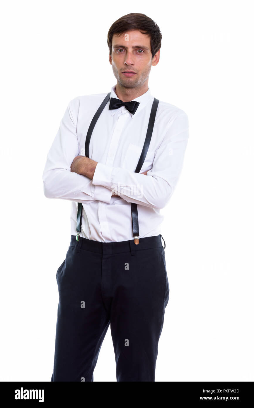 Studio shot of young handsome man standing while wearing suspend Stock ...