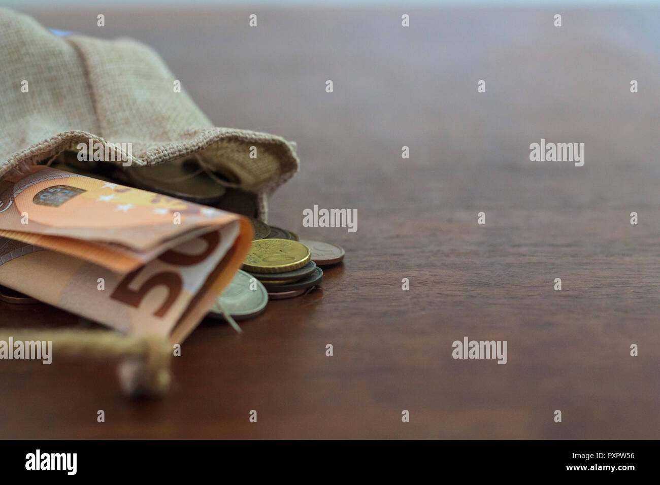 Money spilling from a bag Stock Photo - Alamy