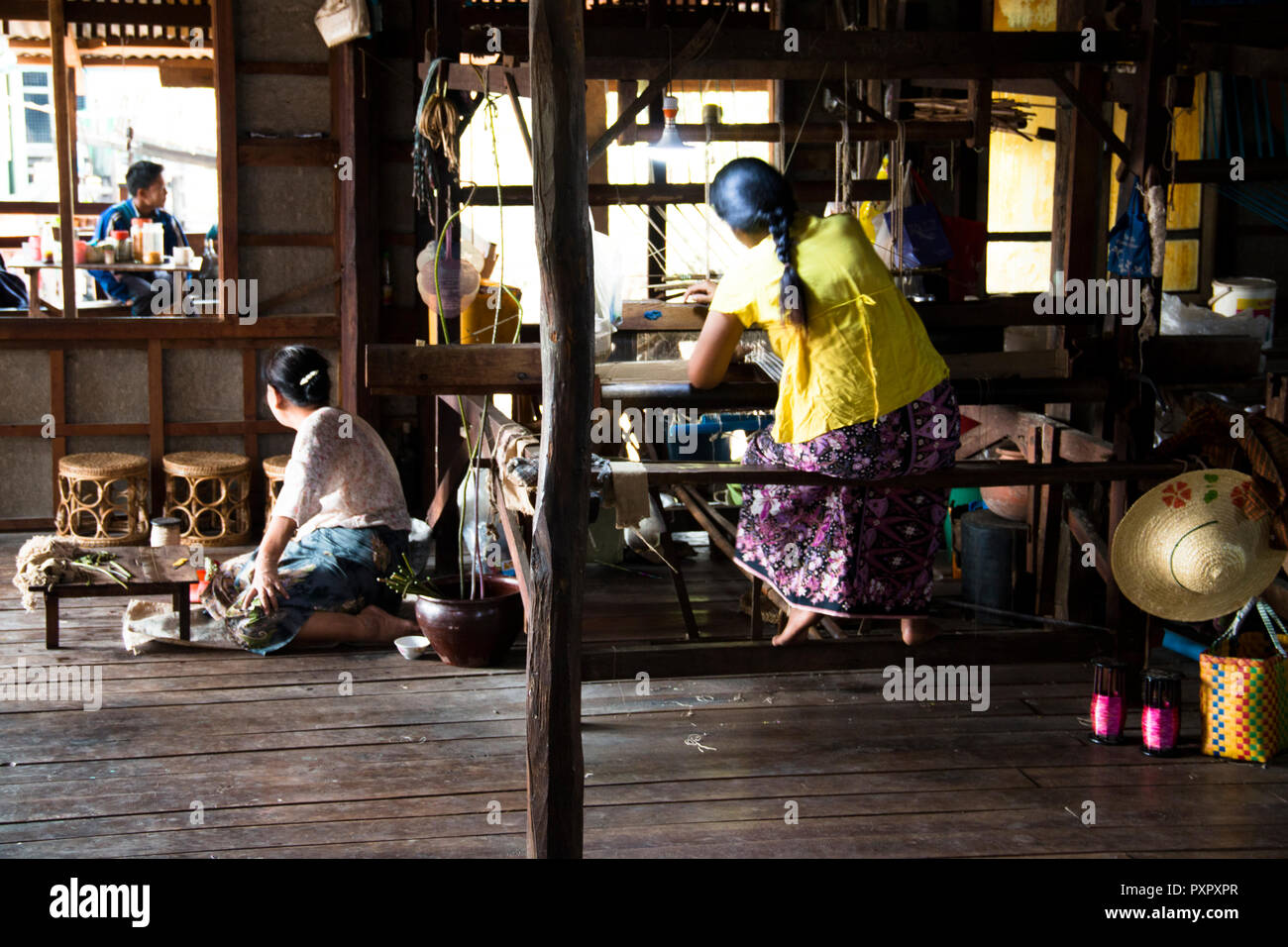 INLE LAKE, MYANMAR - MARCH 2018: People weaving clothes in the ...