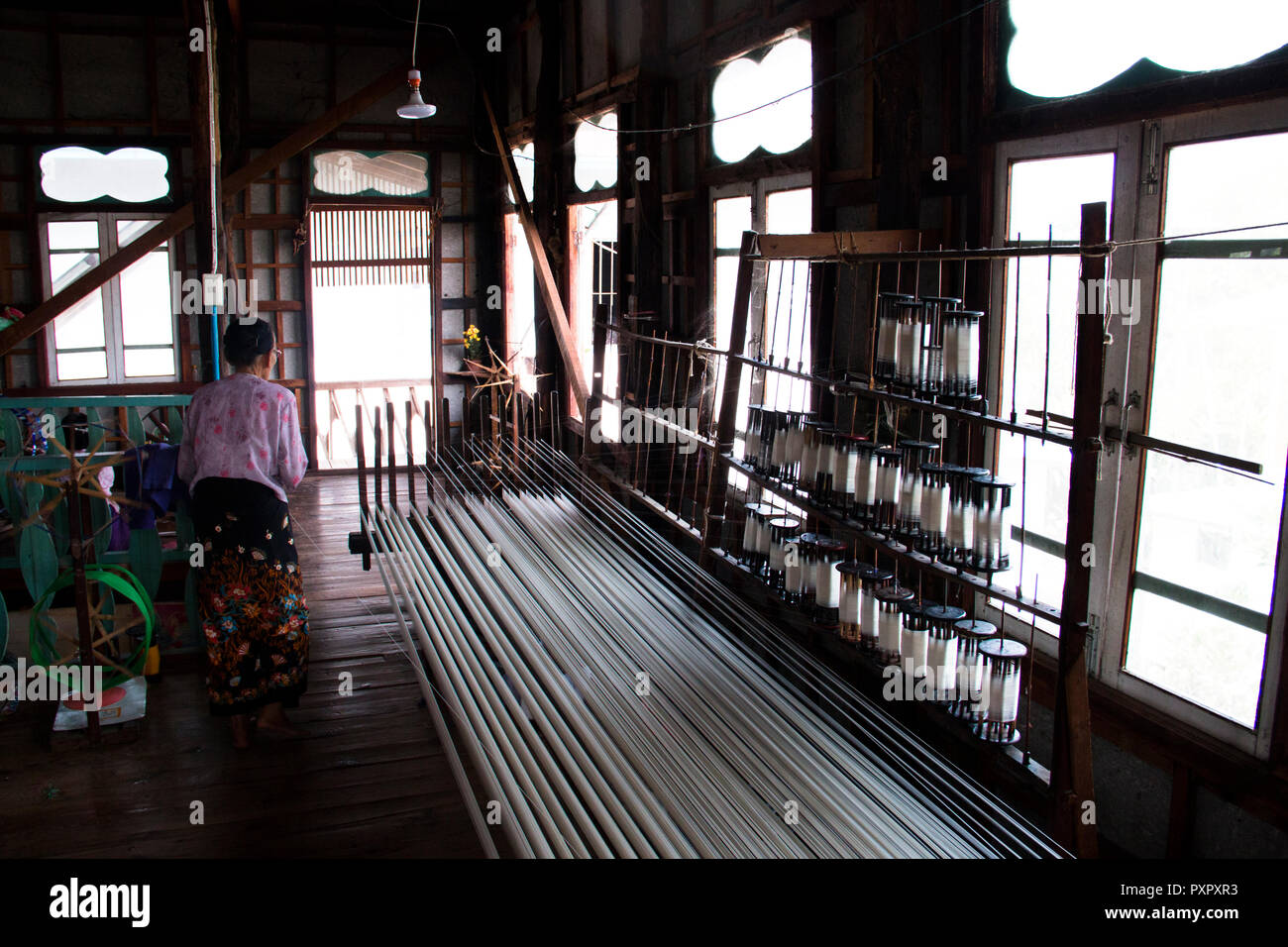 INLE LAKE, MYANMAR - MARCH 2018: People weaving clothes in the ...