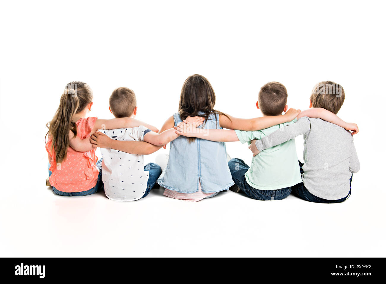 Back view of child group sitting on floor looking at wall Stock Photo ...