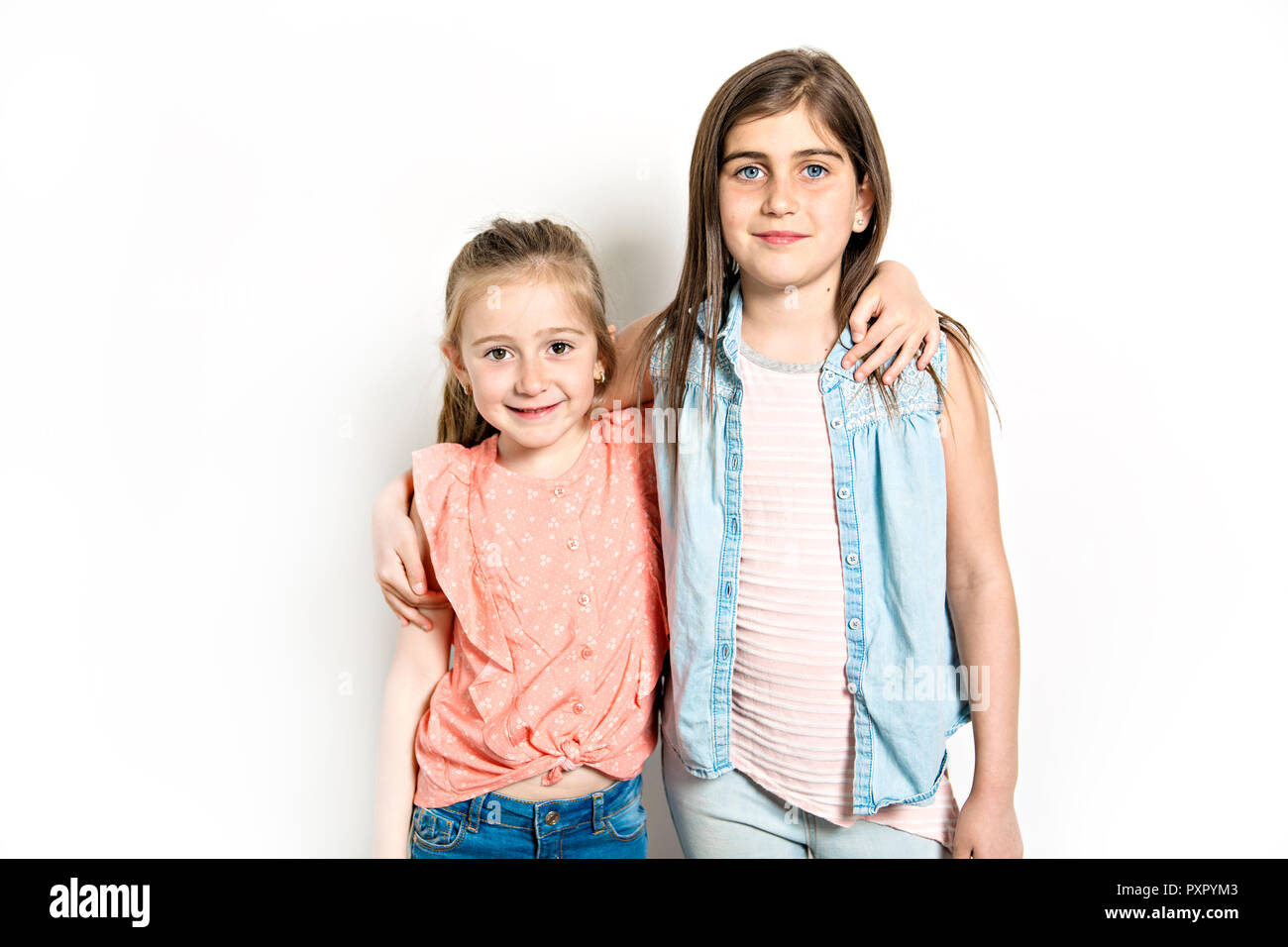 Two Sisters portrait in studio white background Stock Photo - Alamy