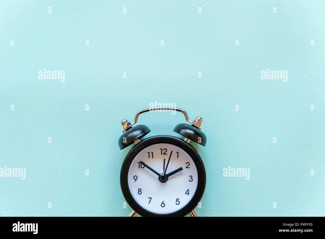 Ringing twin bell vintage classic alarm clock Isolated on blue pastel ...