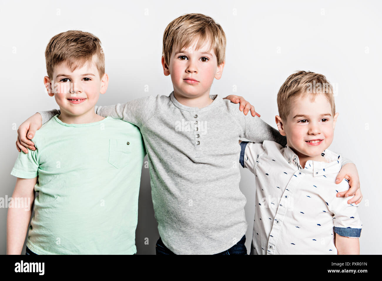 three friends brother together on studio white background Stock Photo ...