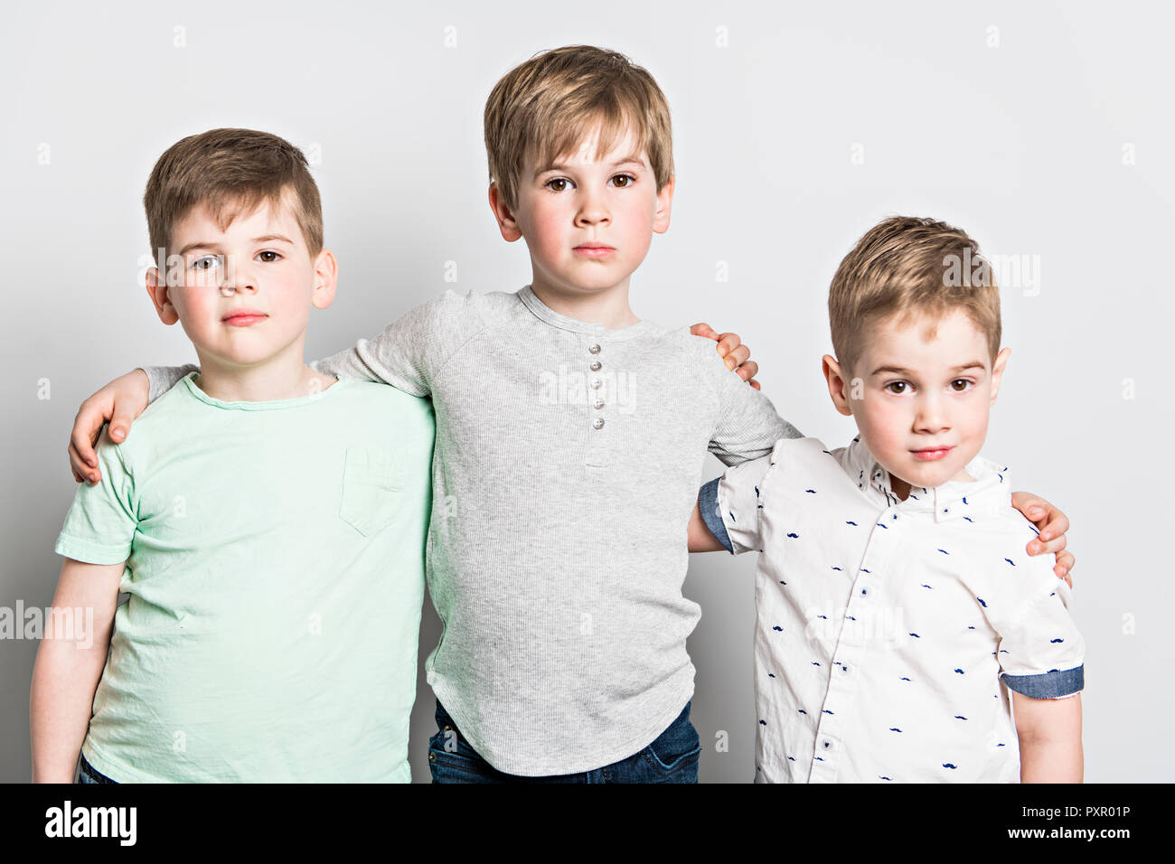 three friends brother together on studio white background Stock Photo ...