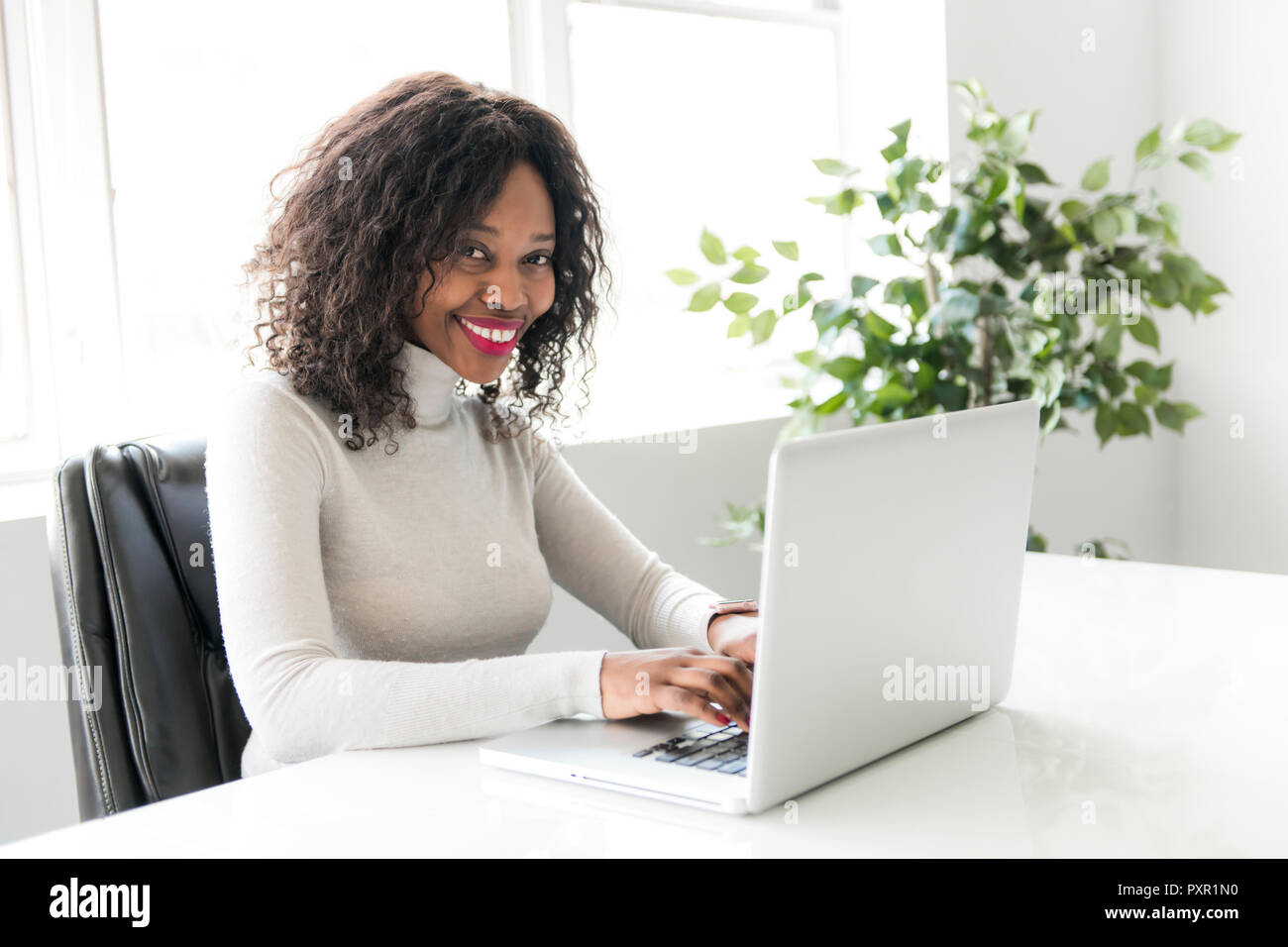 Beautiful black woman working on self employee office Stock Photo - Alamy