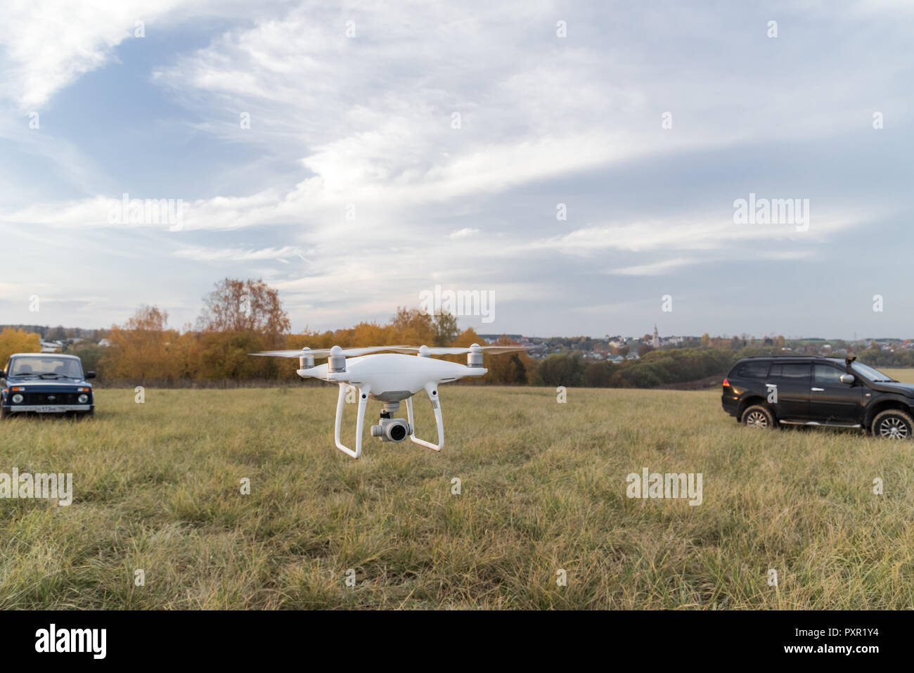 Demonstration flight drone DJI Phantom 4 Pro in the autumn forest ...
