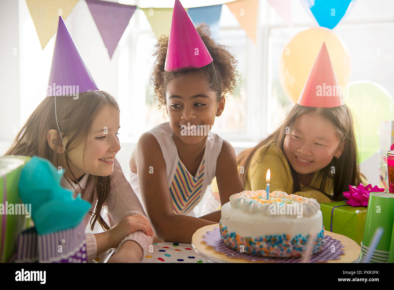A Group of three adorable kids having fun at birthday party Stock Photo ...