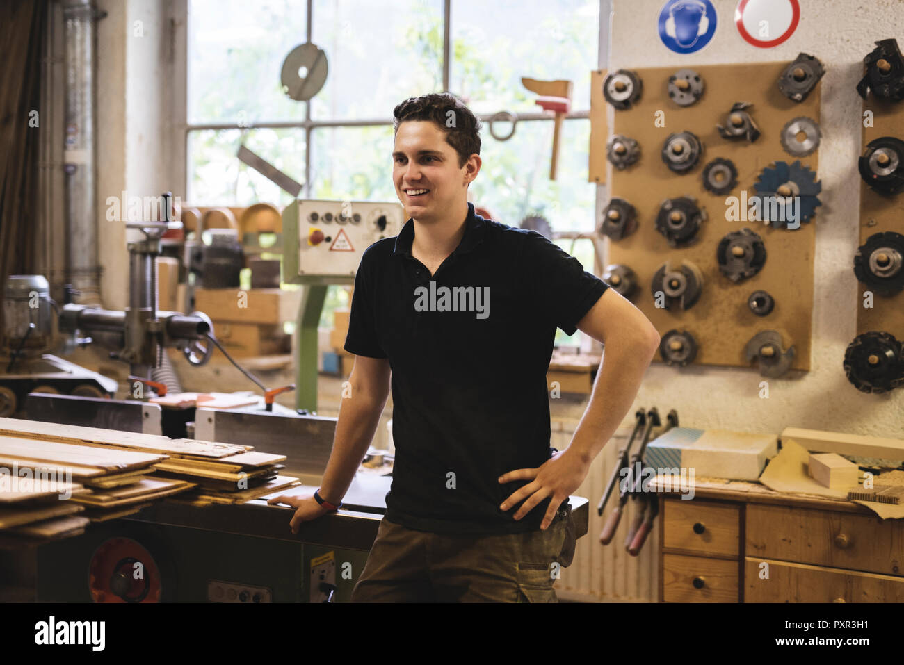 Smiling carpenter standing in his workshop Stock Photo - Alamy