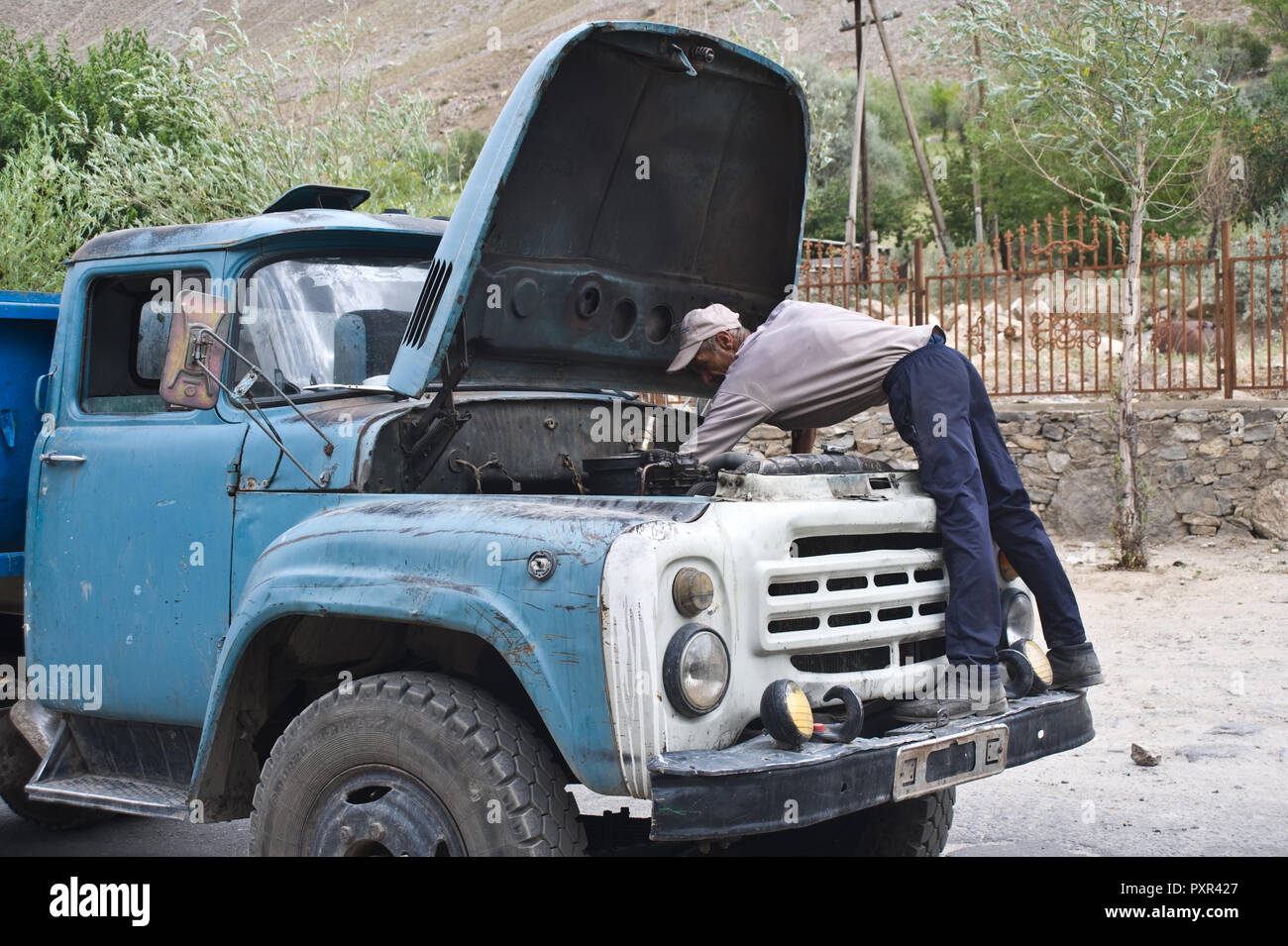 Driver repairing the motor of a Gaz 53 truck ( Tajikistan Stock Photo ...