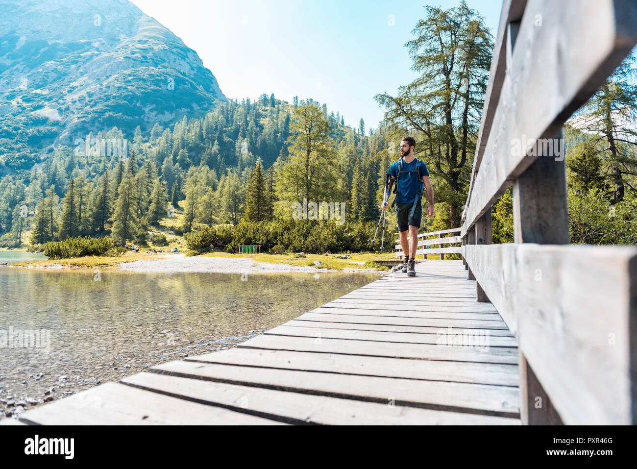 Austria, Tyrol, Hiker at Lake Seebensee walking on boardwalk Stock ...