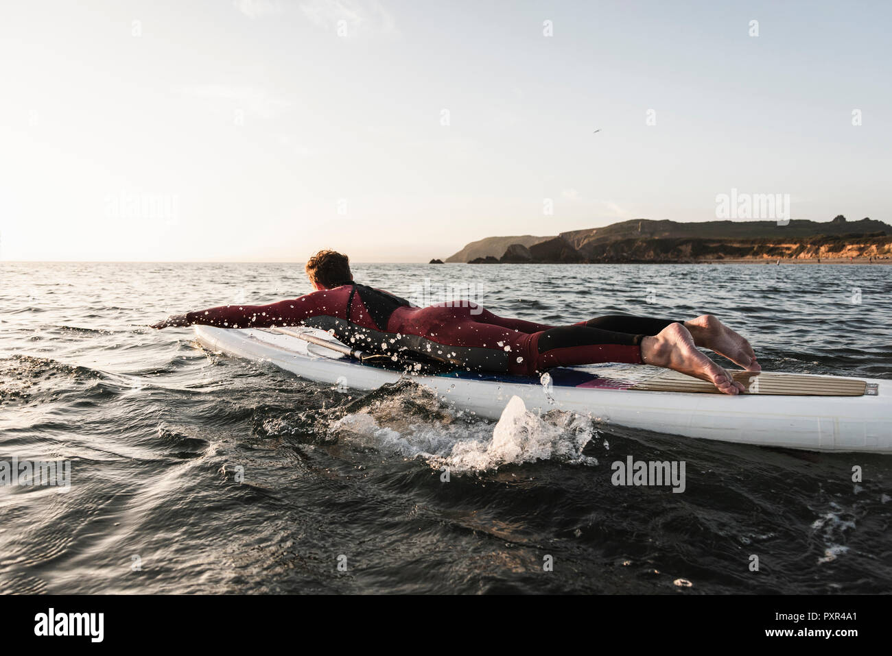 Young 20s on paddle board hi-res stock photography and images - Alamy