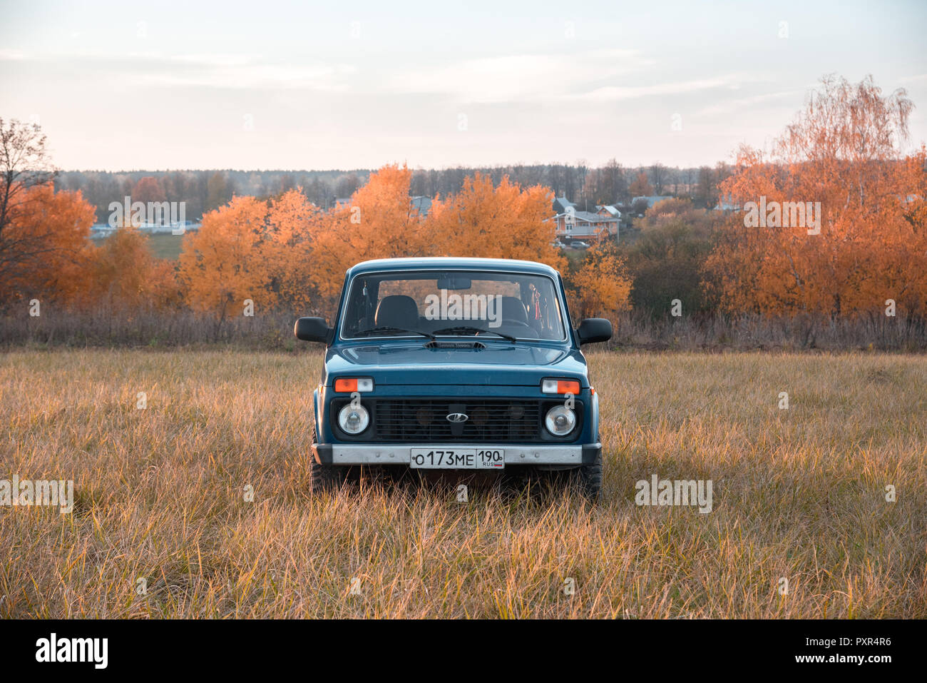 Russian off-road car Lada Niva (VAZ 2121) and trees in autumn on a ...