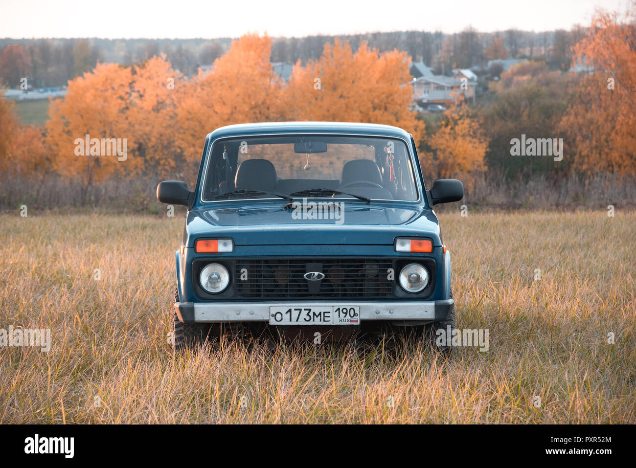 Russian off-road car Lada Niva (VAZ 2121) and trees in autumn on a ...