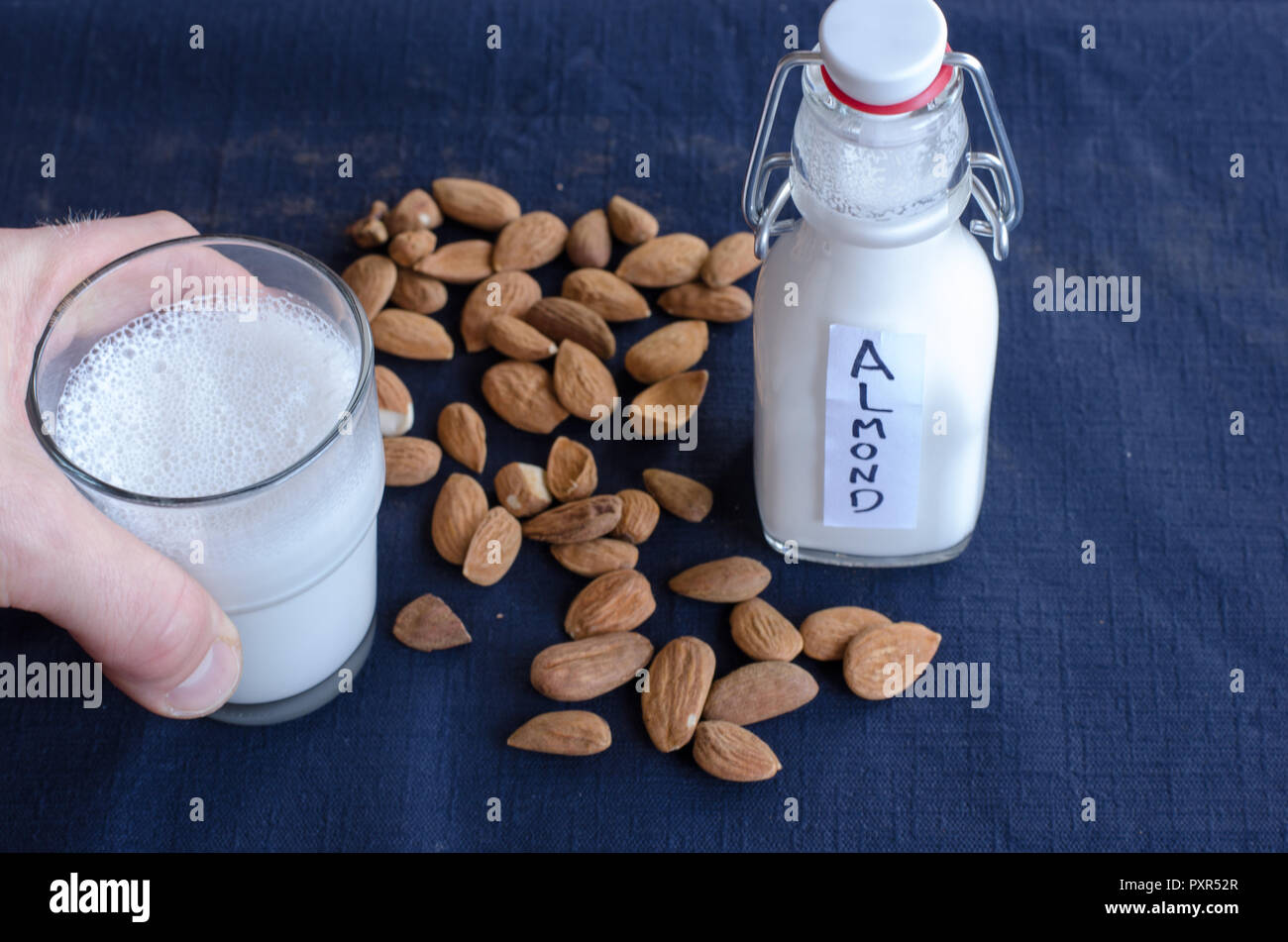 Almond milk in bottle and glass together with ingredients between Stock ...
