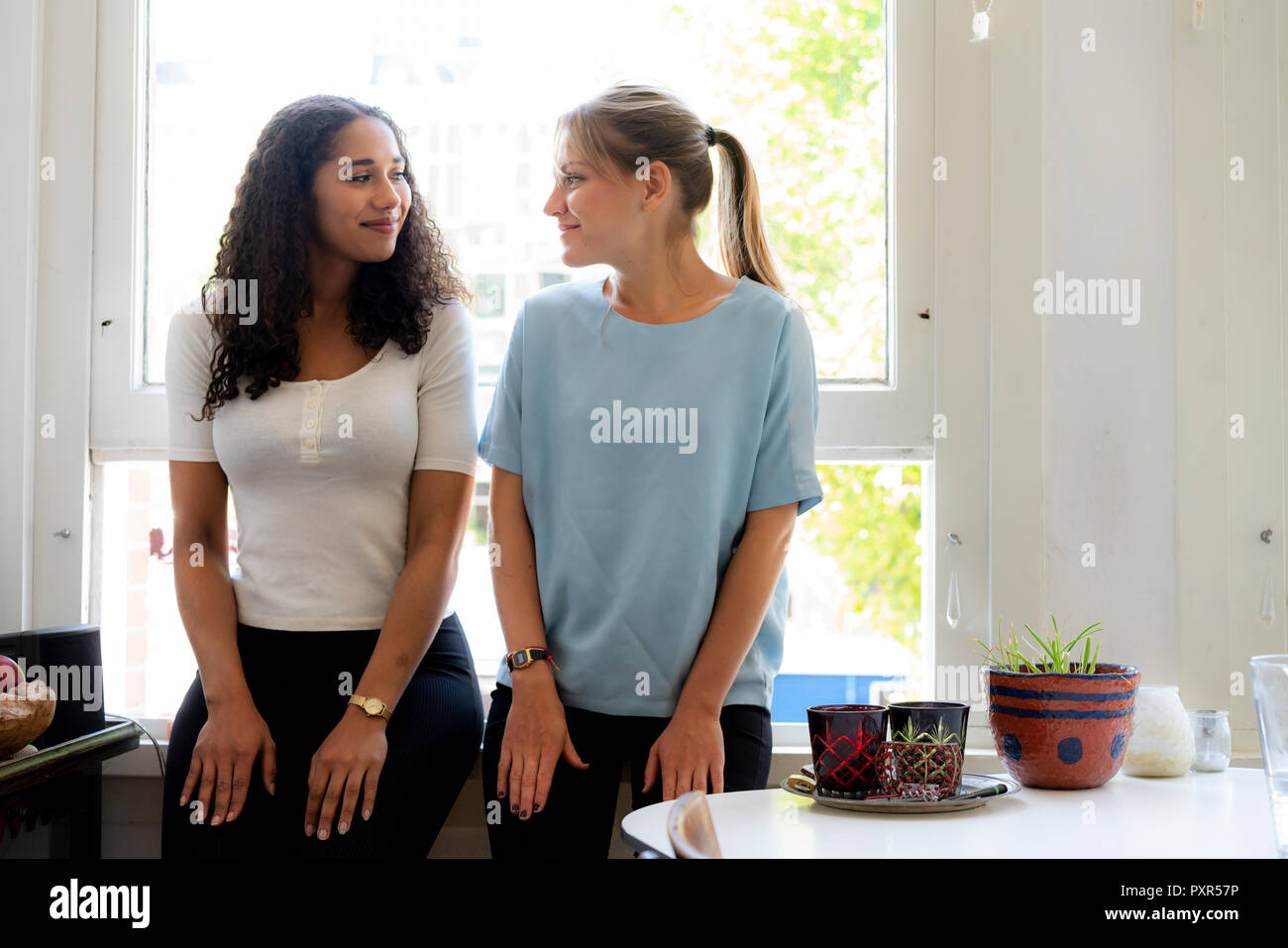 Two women sitting opposite each other hi-res stock photography and ...