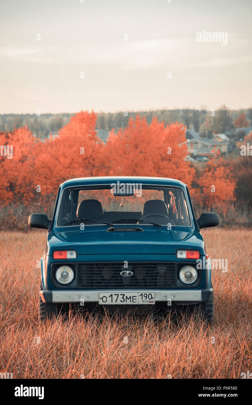 Russian off-road car Lada Niva (VAZ 2121) and trees in autumn on a ...