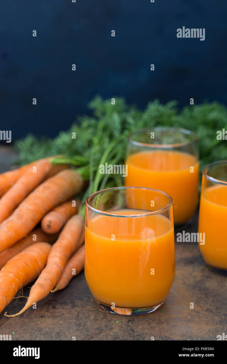 Three glasses fresh carrot juice carrots hi-res stock photography and ...
