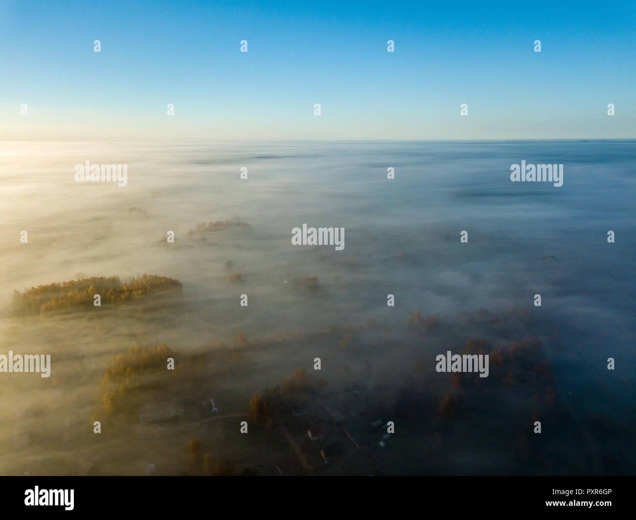 drone image. aerial view of rural area with sun halo above mist. high ...