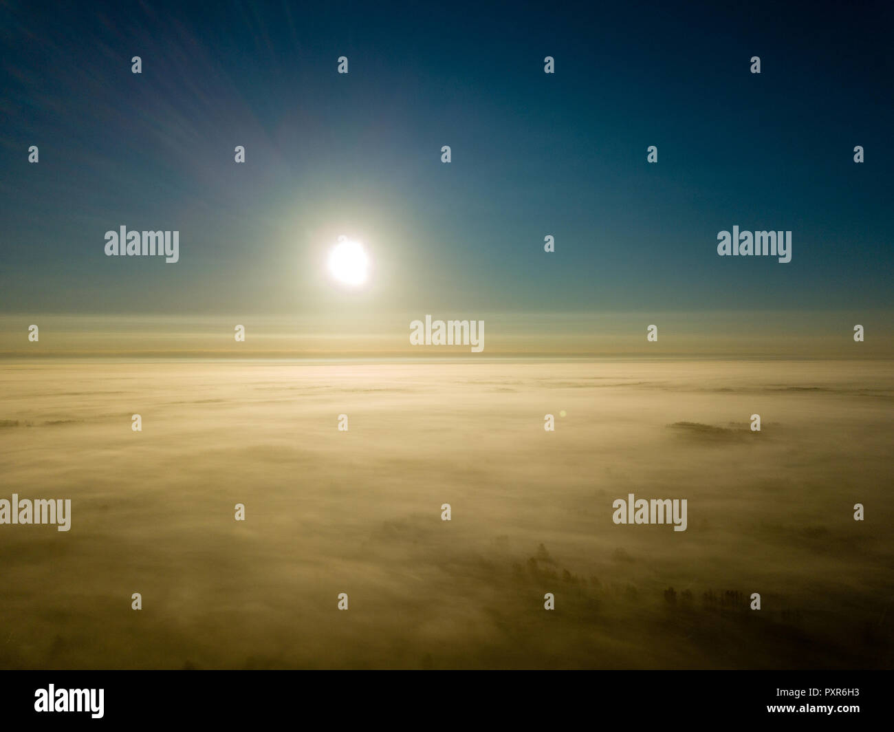 drone image. aerial view of rural area with sun halo above mist. high ...