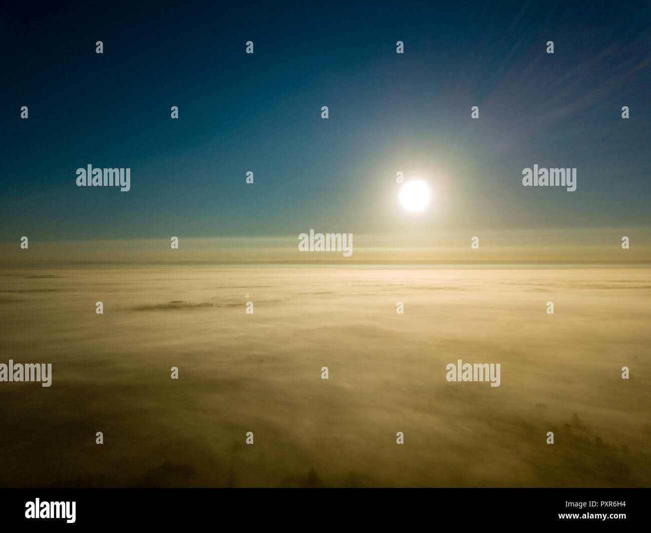 drone image. aerial view of rural area with sun halo above mist. high ...