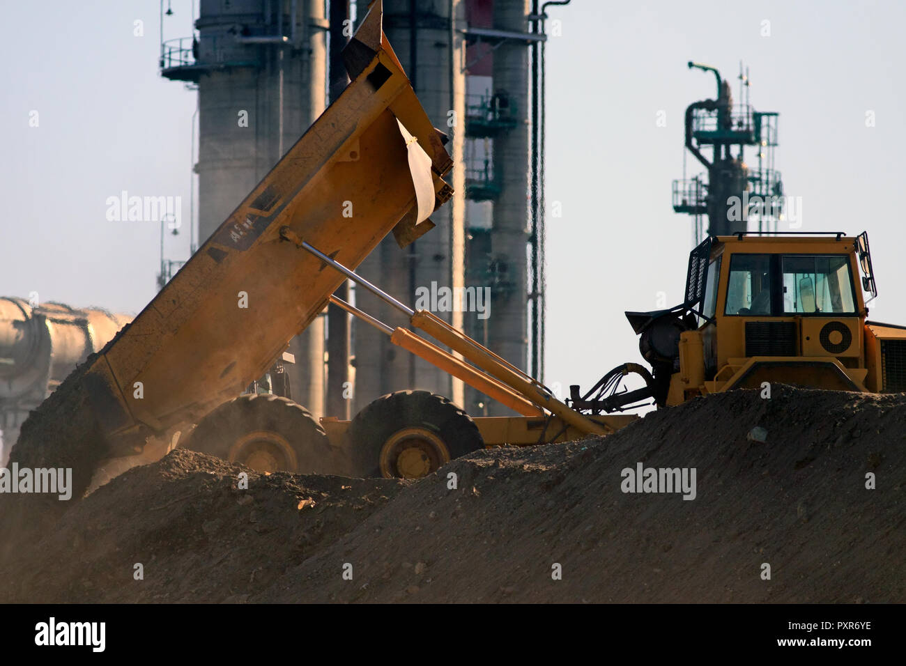 Close-up of an heavy dump truck unloading dirt during works of the ...