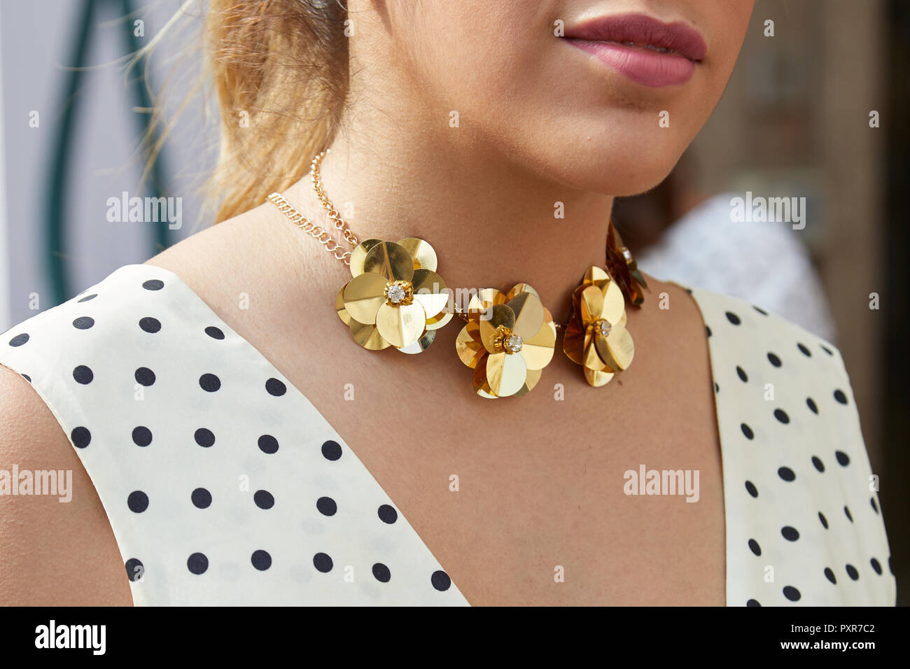 MILAN, ITALY - SEPTEMBER 22, 2018: Woman with golden necklace with ...