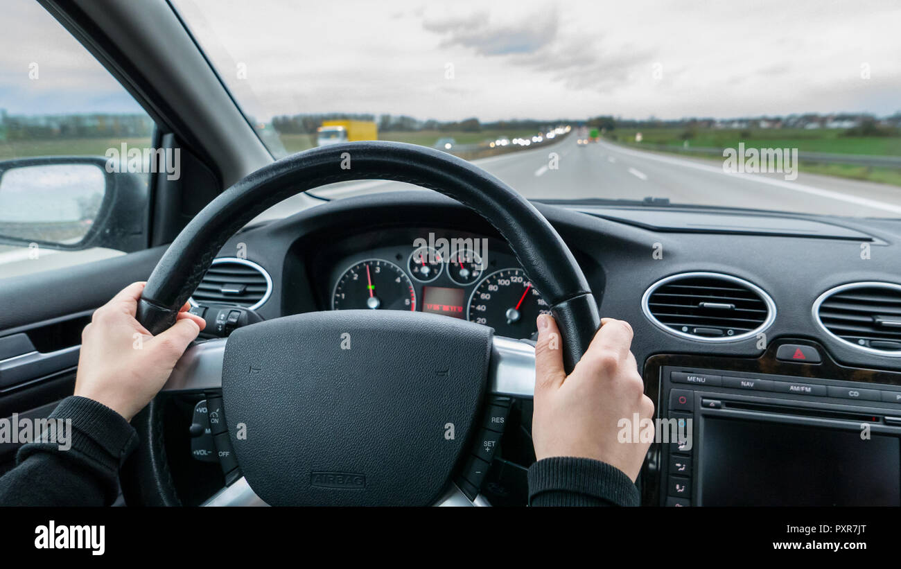 Young woman driving fast fast car on motorway Stock Photo - Alamy