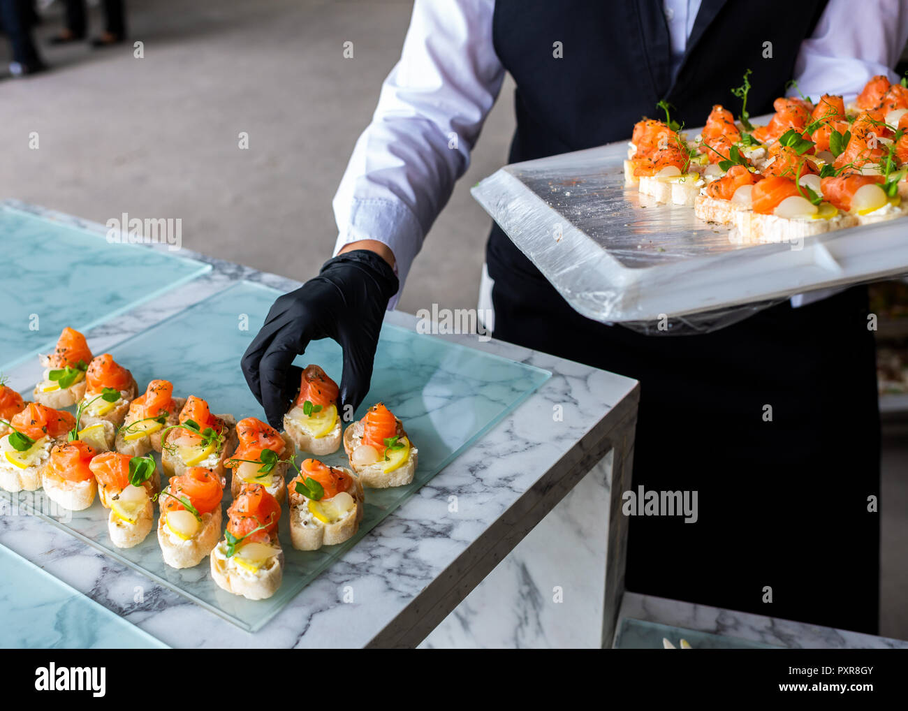 gloved hands putting food Stock Photo - Alamy