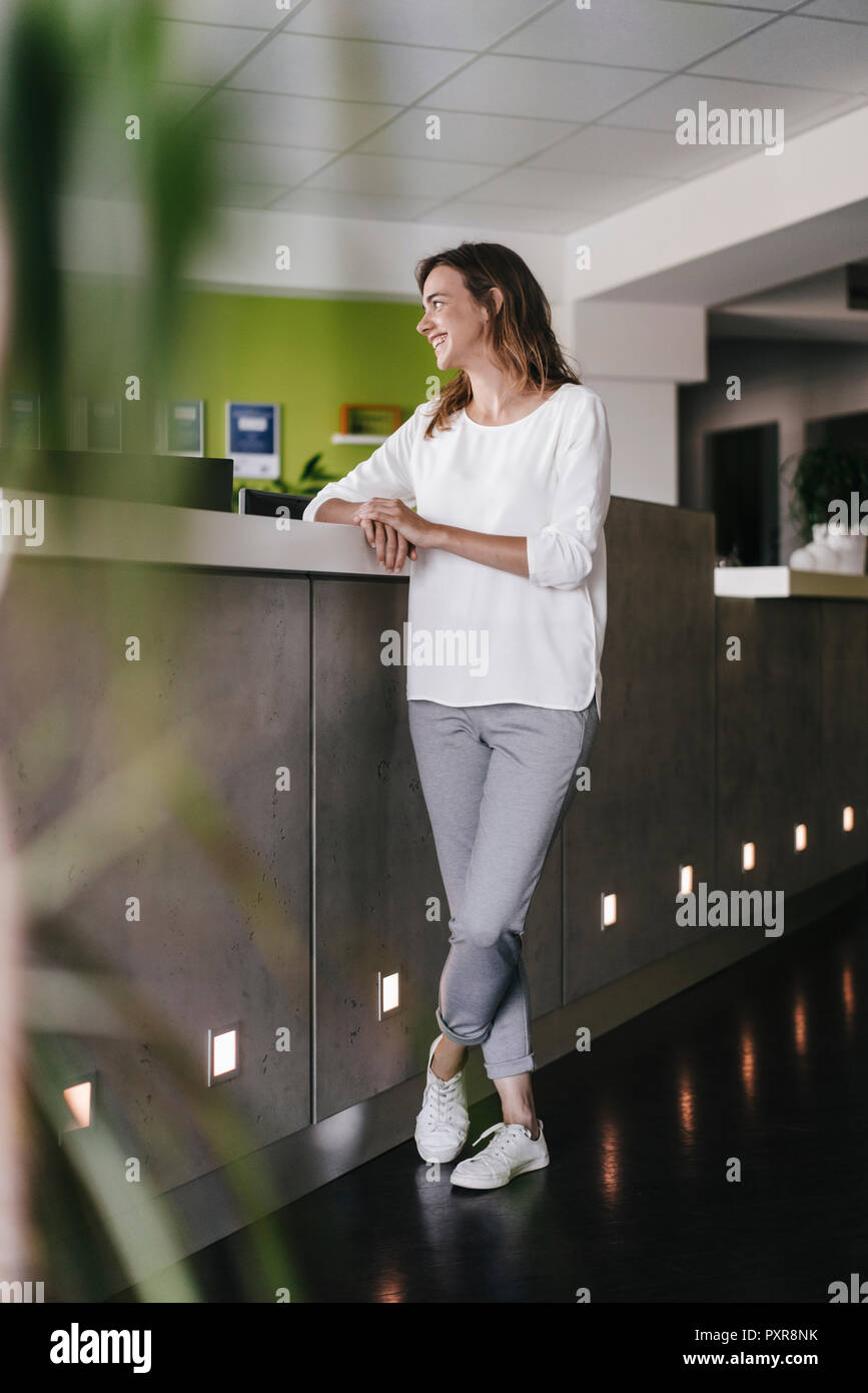 Businesswoman waiting at reception Stock Photo - Alamy