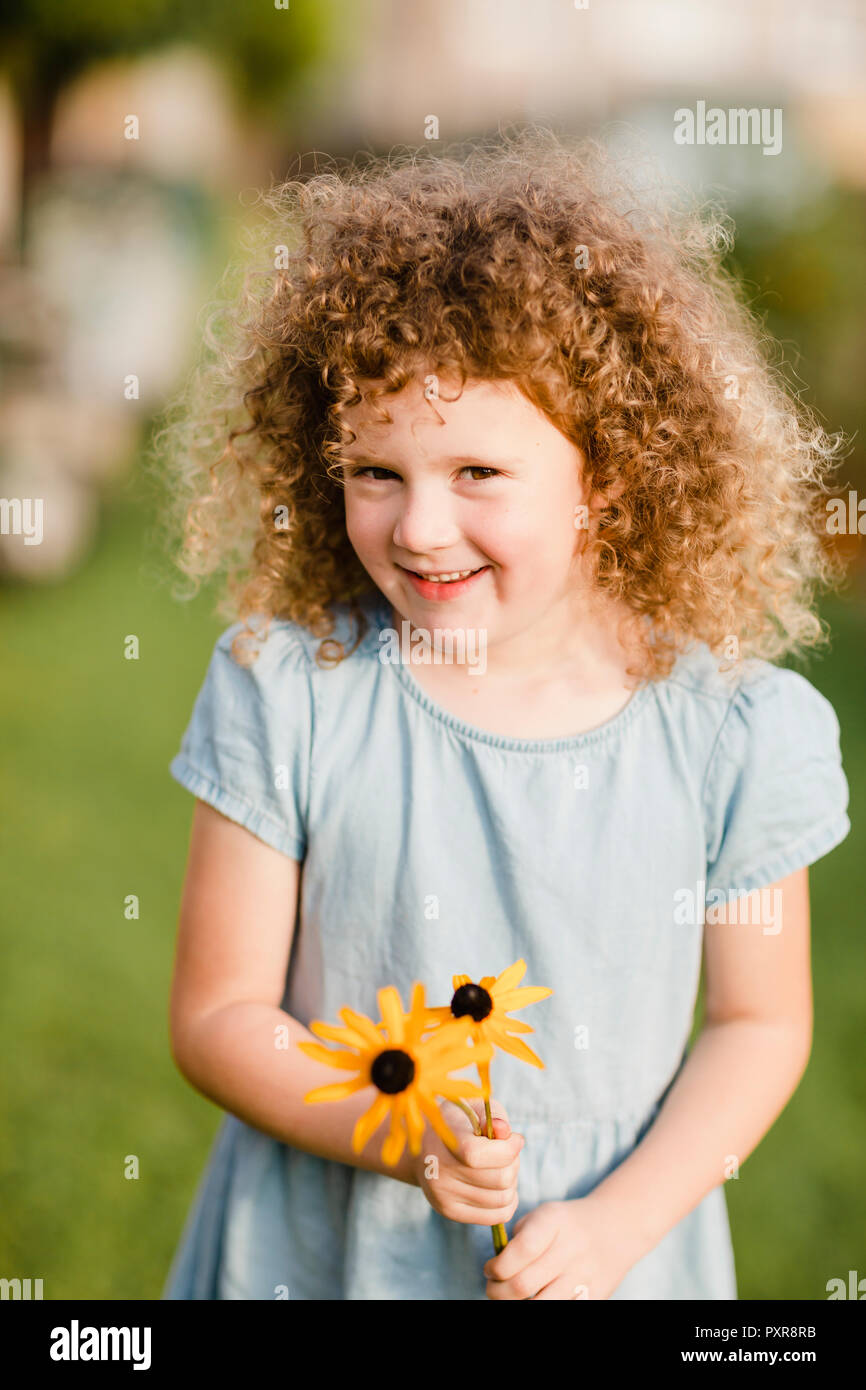 Happy Little Girl With Flower