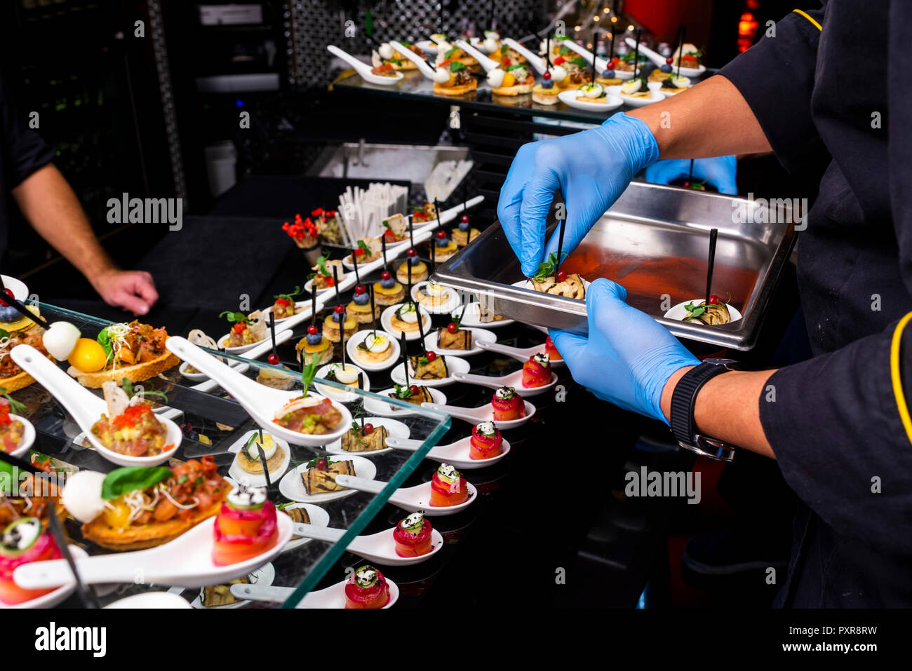 gloved hands putting food Stock Photo - Alamy