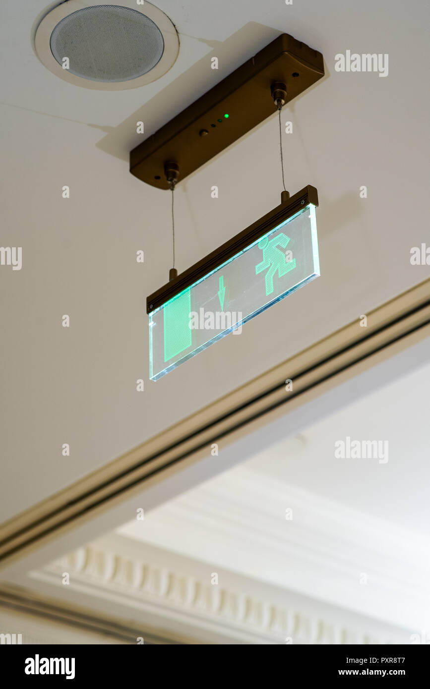 exit sign under the ceiling Stock Photo - Alamy