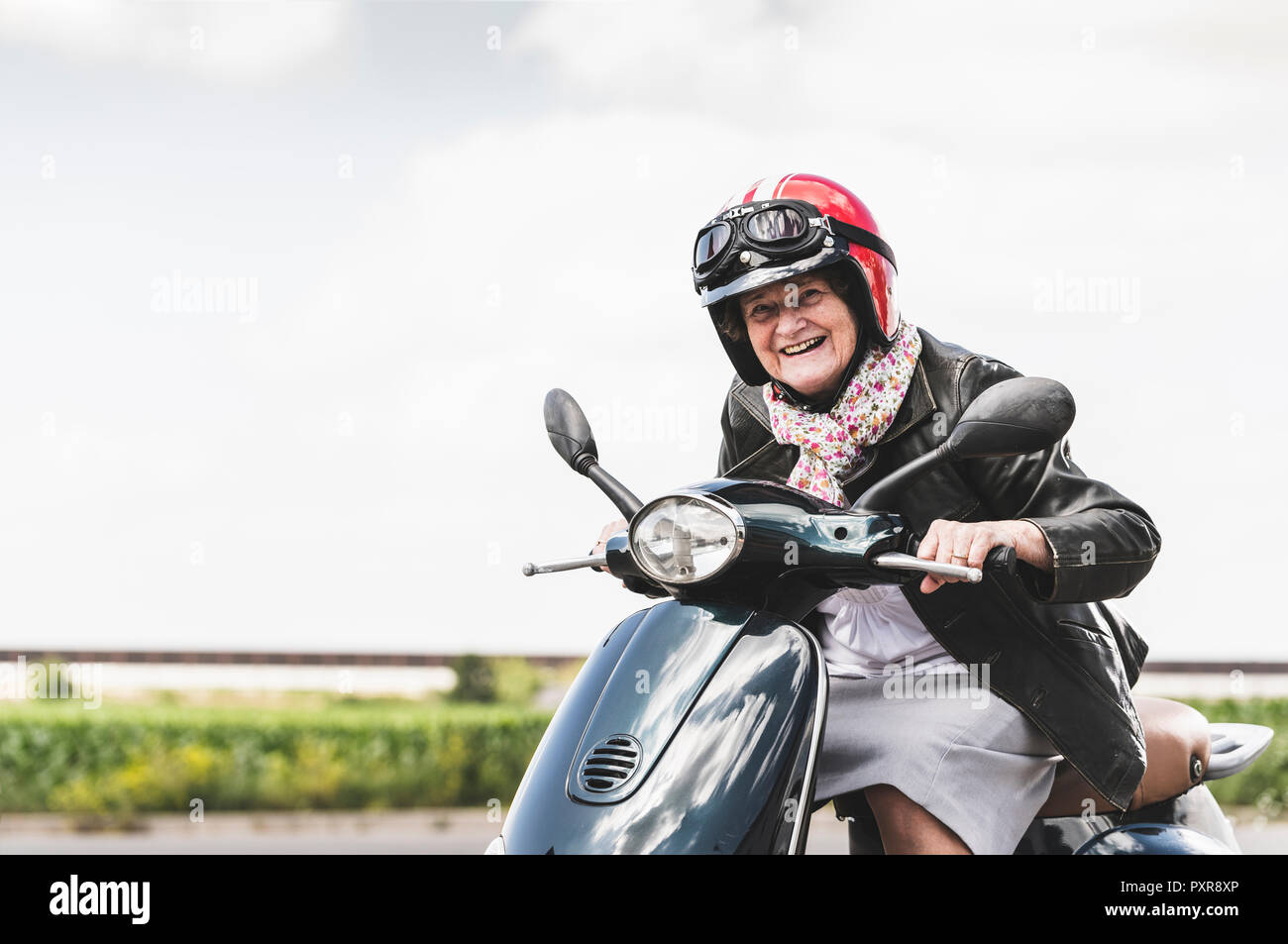 Lady riding scooter hi-res stock photography and images - Alamy