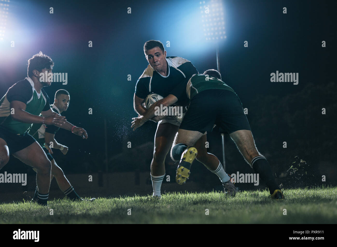 Strong rugby players fighting for the ball during the game. Intense ...