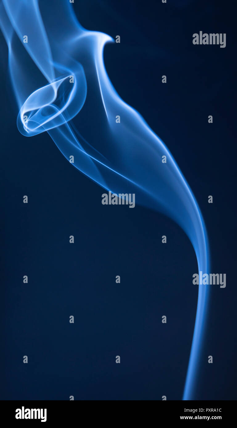 Abstract blue smoke swirls on dark background Stock Photo - Alamy