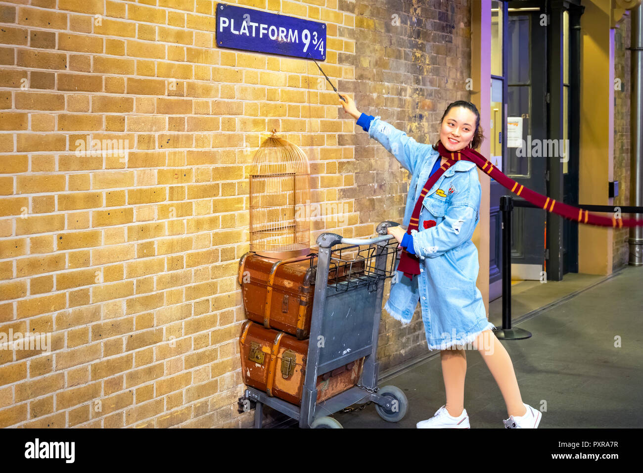 London, UK - May 12 2018: Unidentified people poses at the platform 9 3 ...
