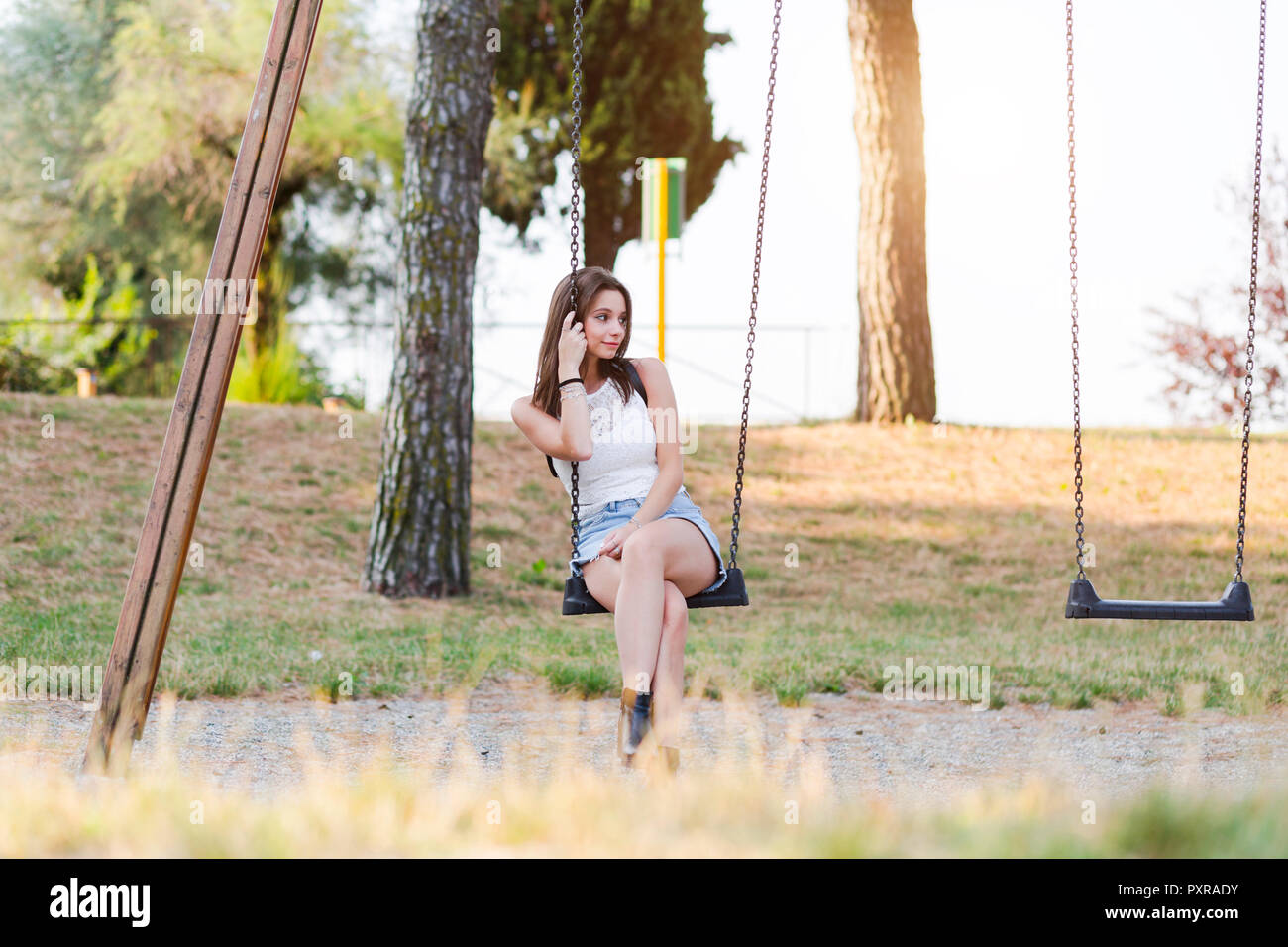 Woman sitting on a swing hi-res stock photography and images - Alamy