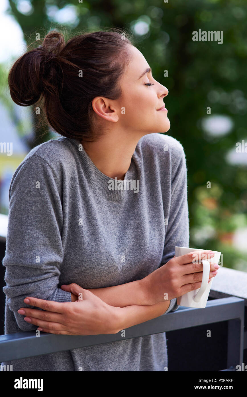 Young woman drinking morning coffee on the balcony Stock Photo - Alamy