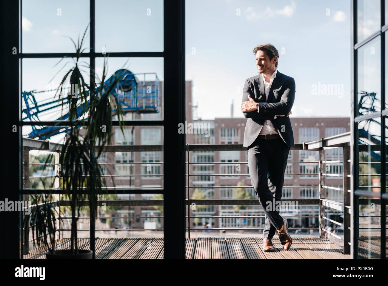 Man standing on balcony arms hi-res stock photography and images - Alamy