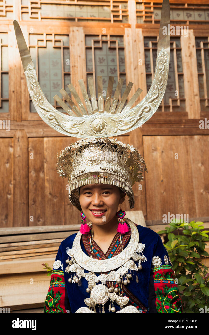 China, Guizhou, portrait of a young Miao woman wearing traditional ...