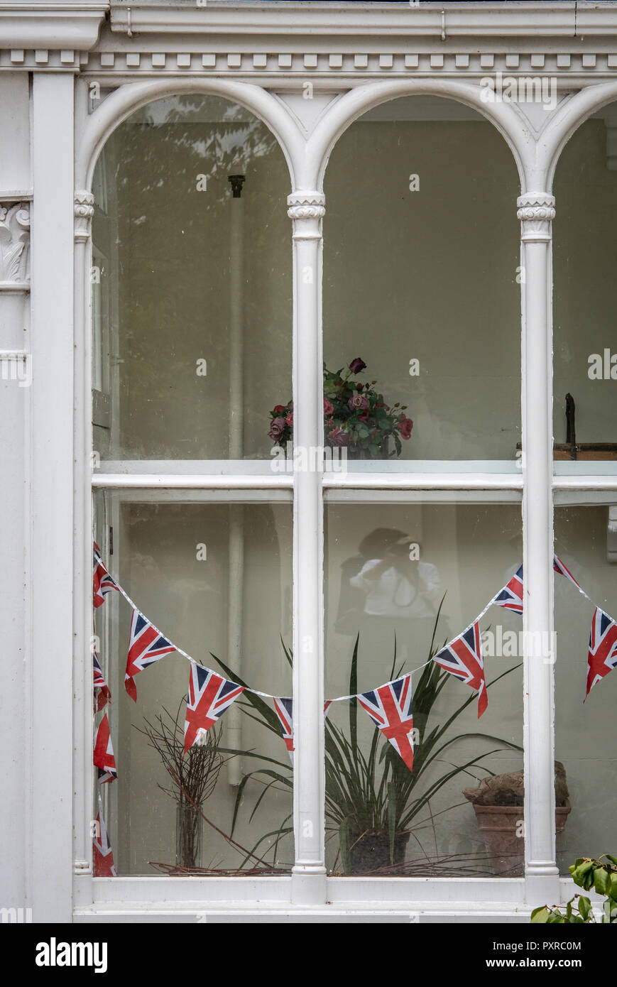 A window looks into a room decorated by union jack flags in Yorkshire ...