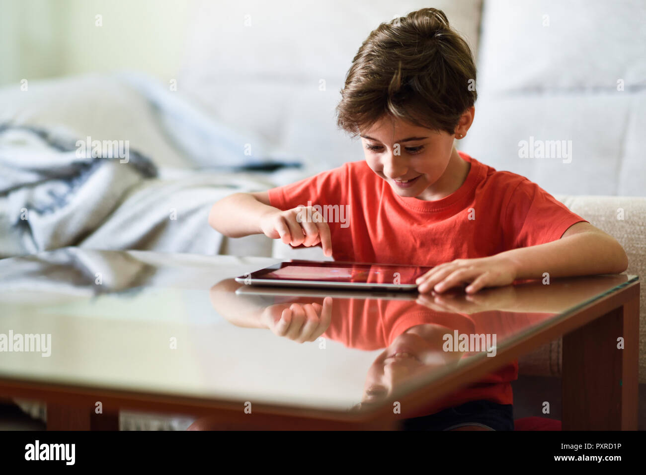 Little girl using digital tablet at home Stock Photo - Alamy