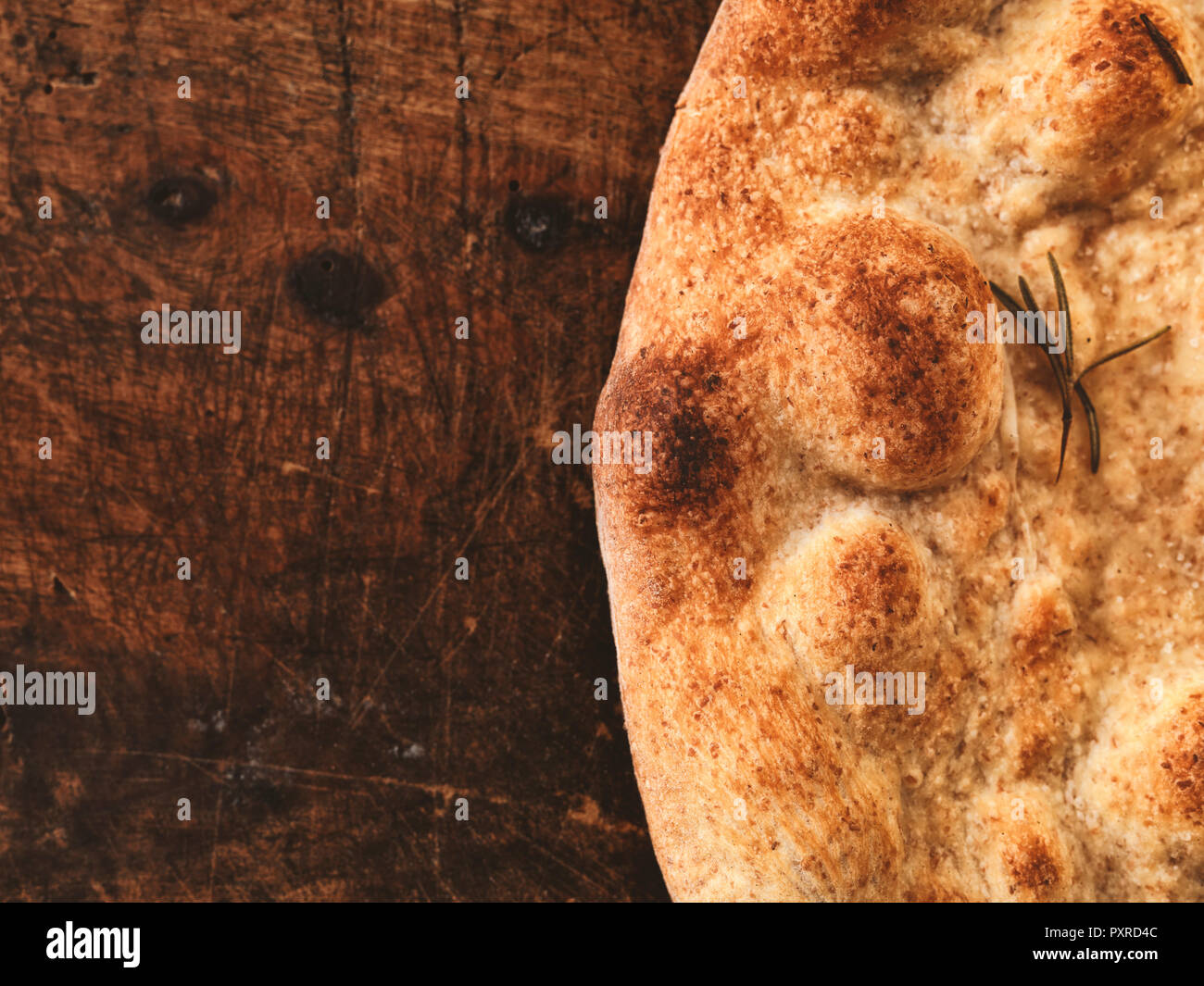 Focaccia with rosemary on cutting board Stock Photo - Alamy