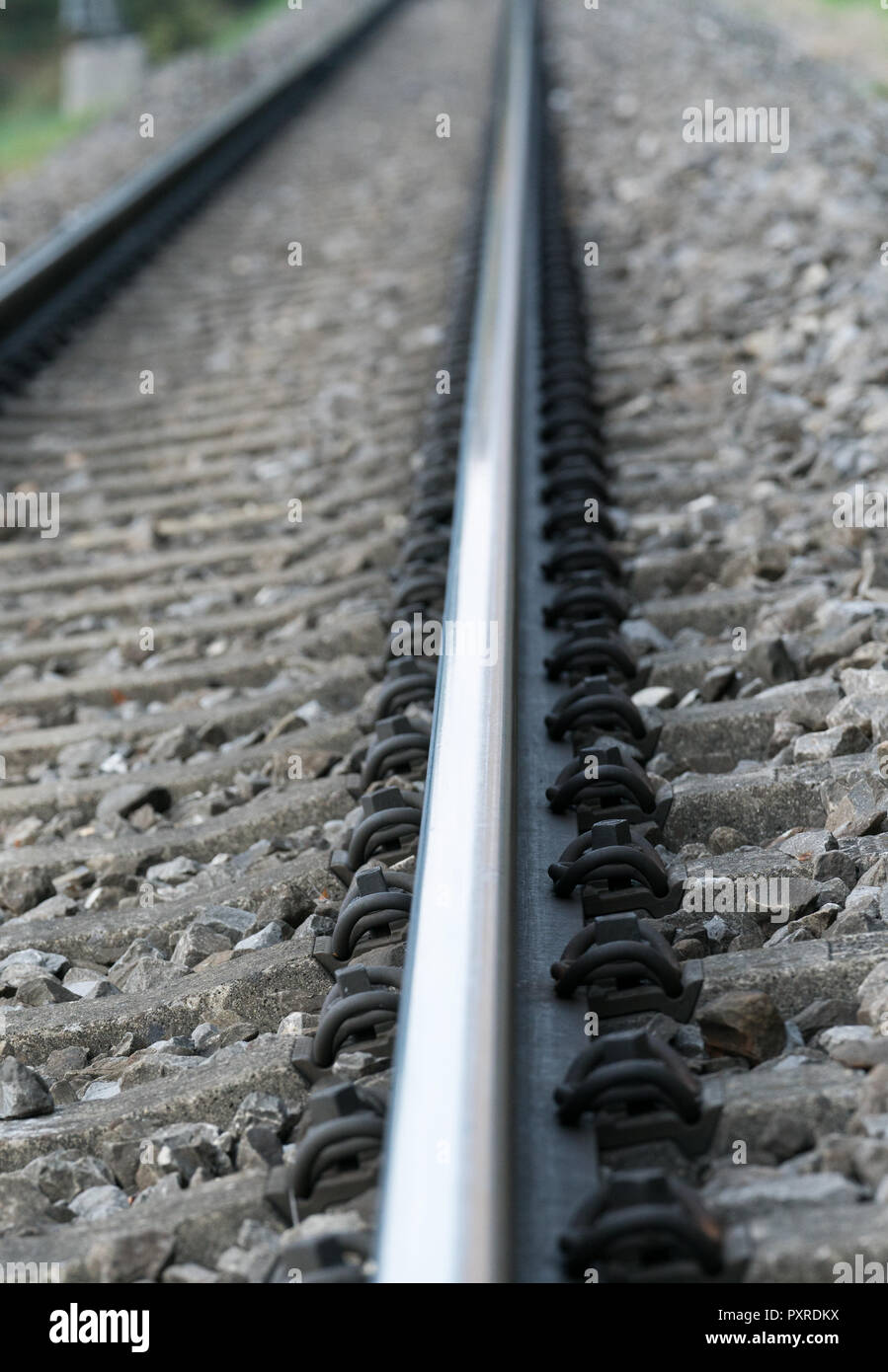 narrow railroad tracks and railroad ties on a rock bed Stock Photo - Alamy