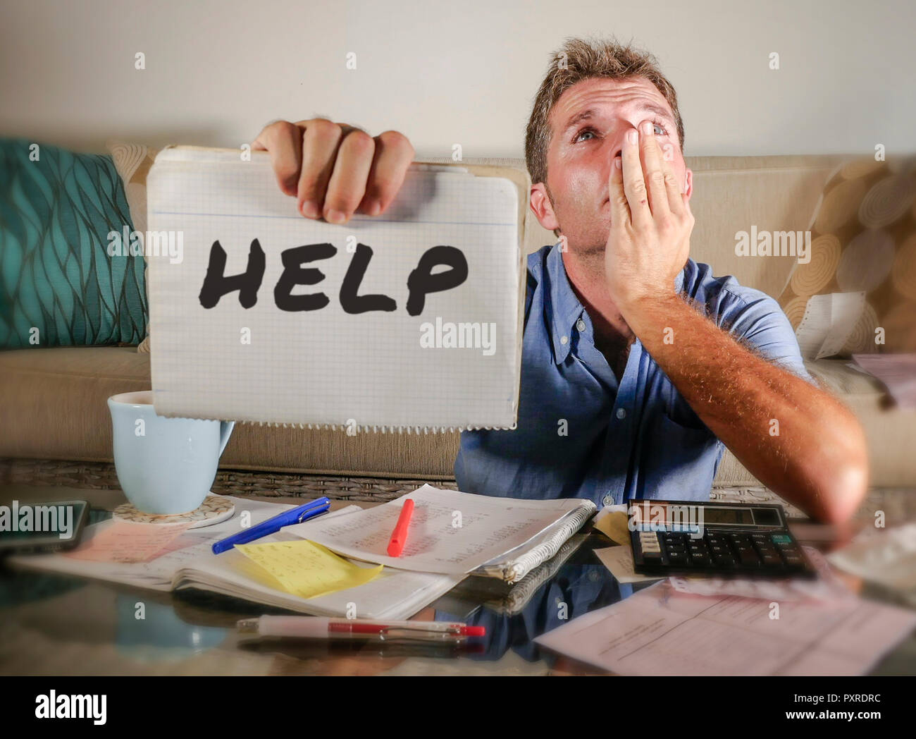 young attractive worried and stressed man at home calculating month tax ...