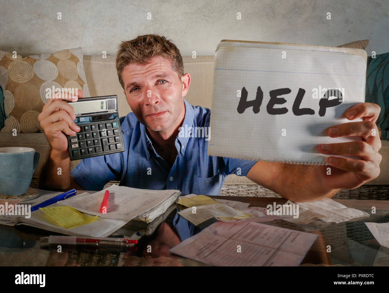 young attractive worried and stressed man at home calculating month tax ...