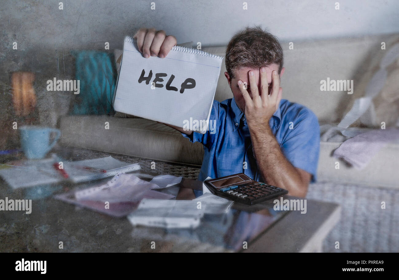 young attractive worried and stressed man at home calculating month tax ...